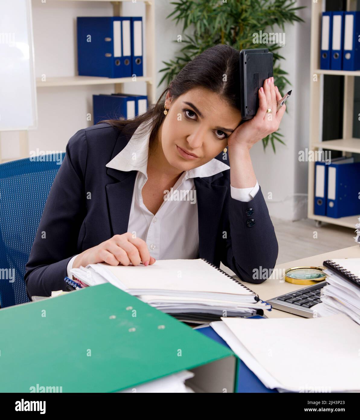 Female employee with too much work in the office Stock Photo - Alamy