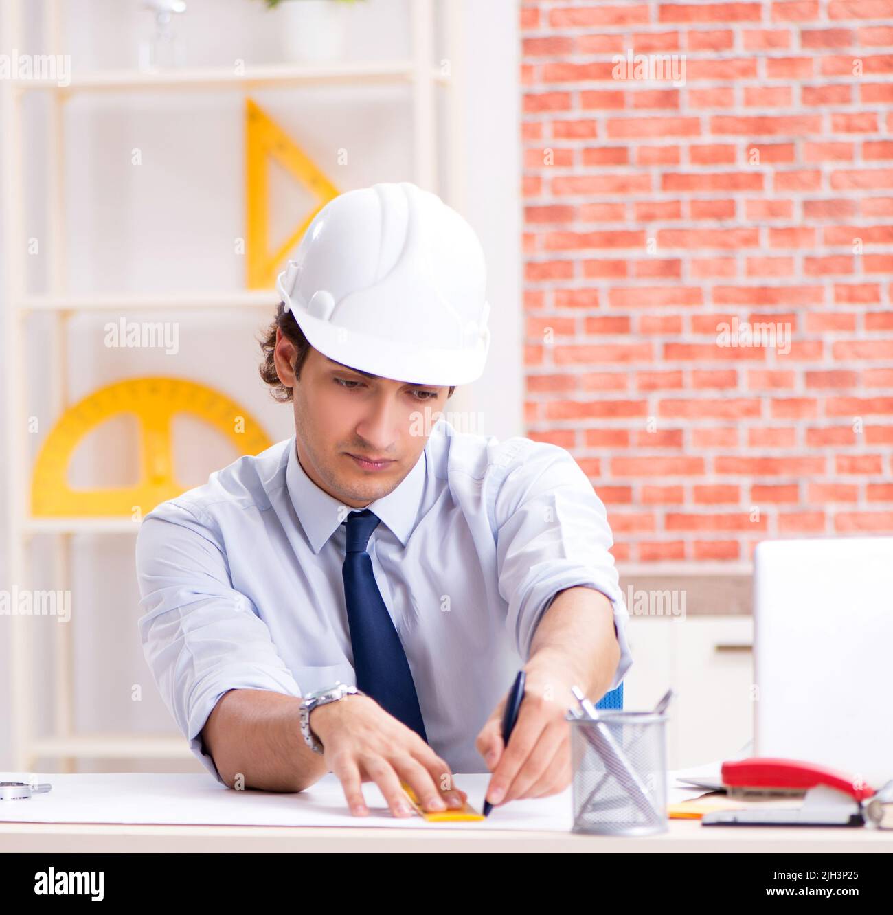Construction supervisor working on blueprints Stock Photo - Alamy
