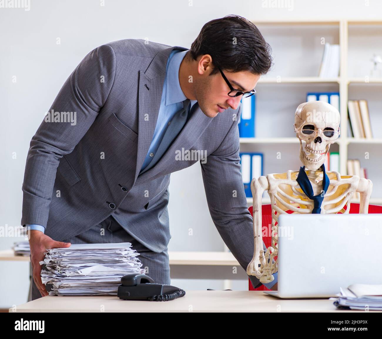 The angry boss yelling at his skeleton employee Stock Photo - Alamy