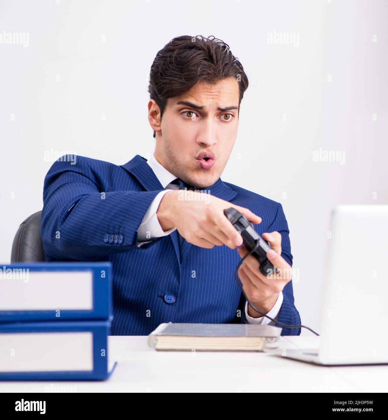 The young handsome businessman playing computer games at work office ...