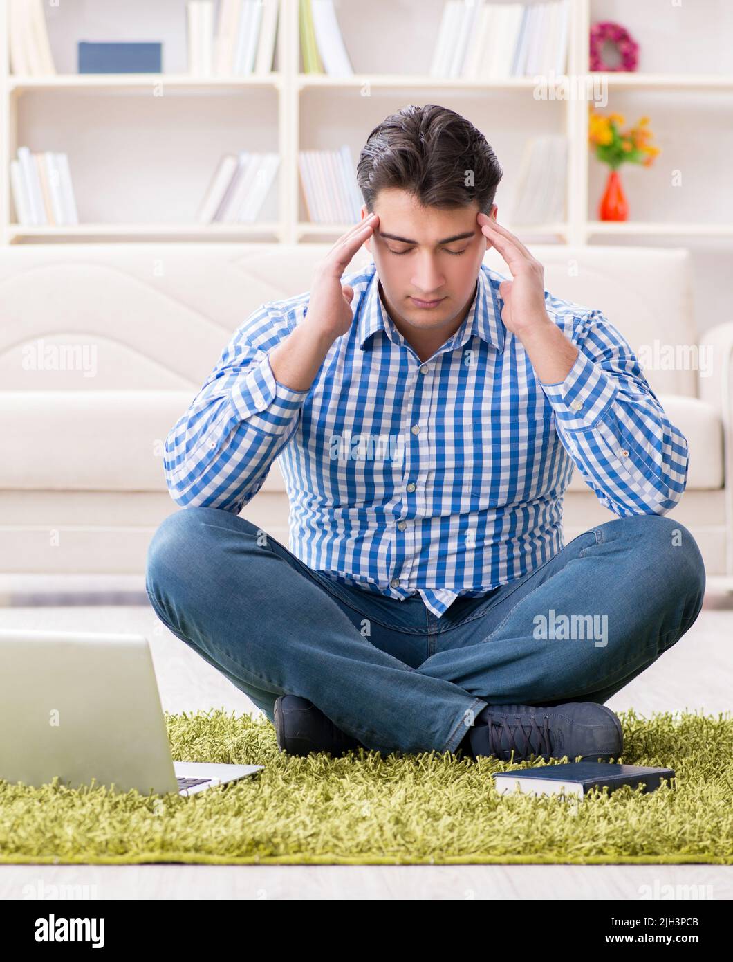 The young handsome man sitting on floor at home Stock Photo - Alamy