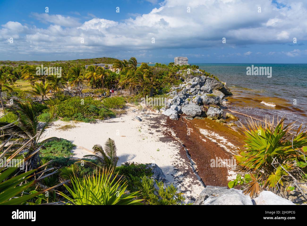 White sand beach with rocks and seaweeds, Mayan Ruins in Tulum, Riviera ...