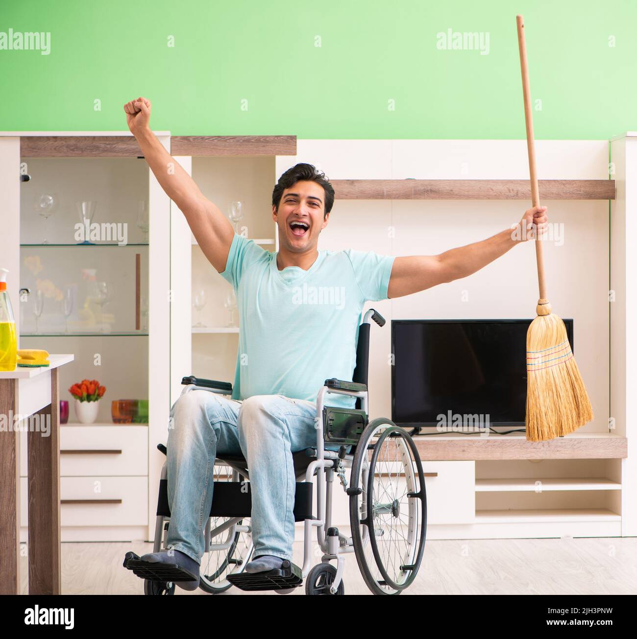 The disabled man on wheelchair cleaning house Stock Photo - Alamy