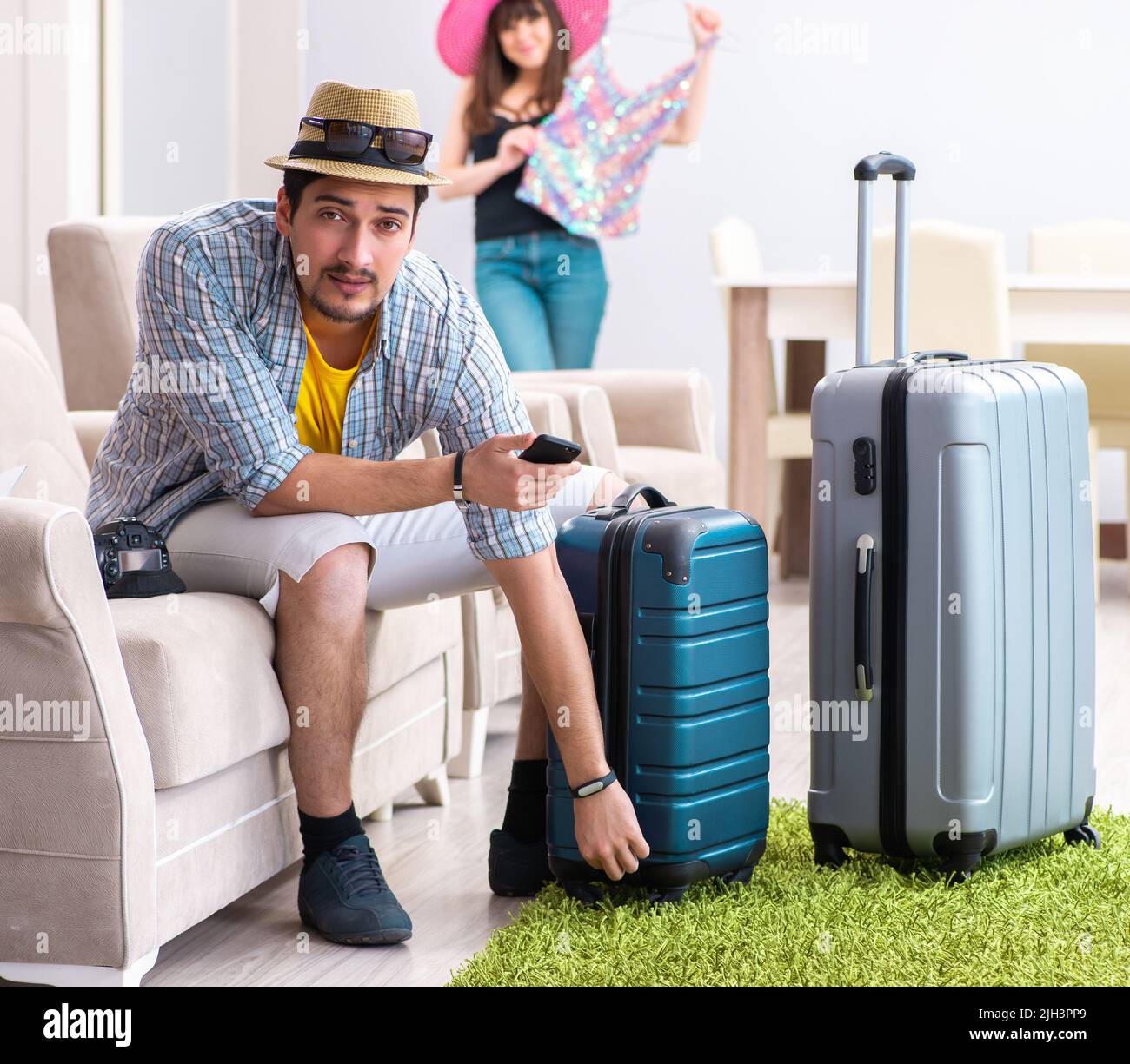 The young family packing for vacation travel Stock Photo - Alamy