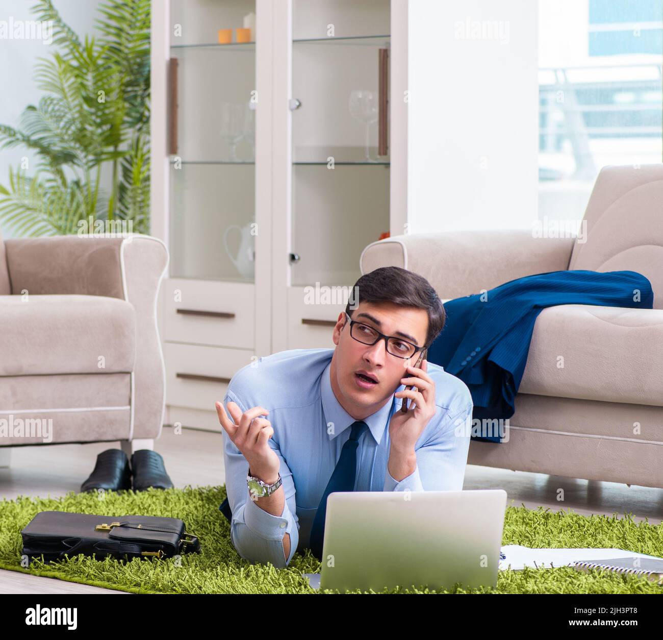 The businessman taking work home and working overtime Stock Photo - Alamy