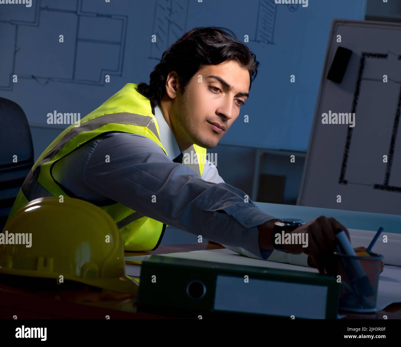 Young construction architect working on project at night Stock Photo ...
