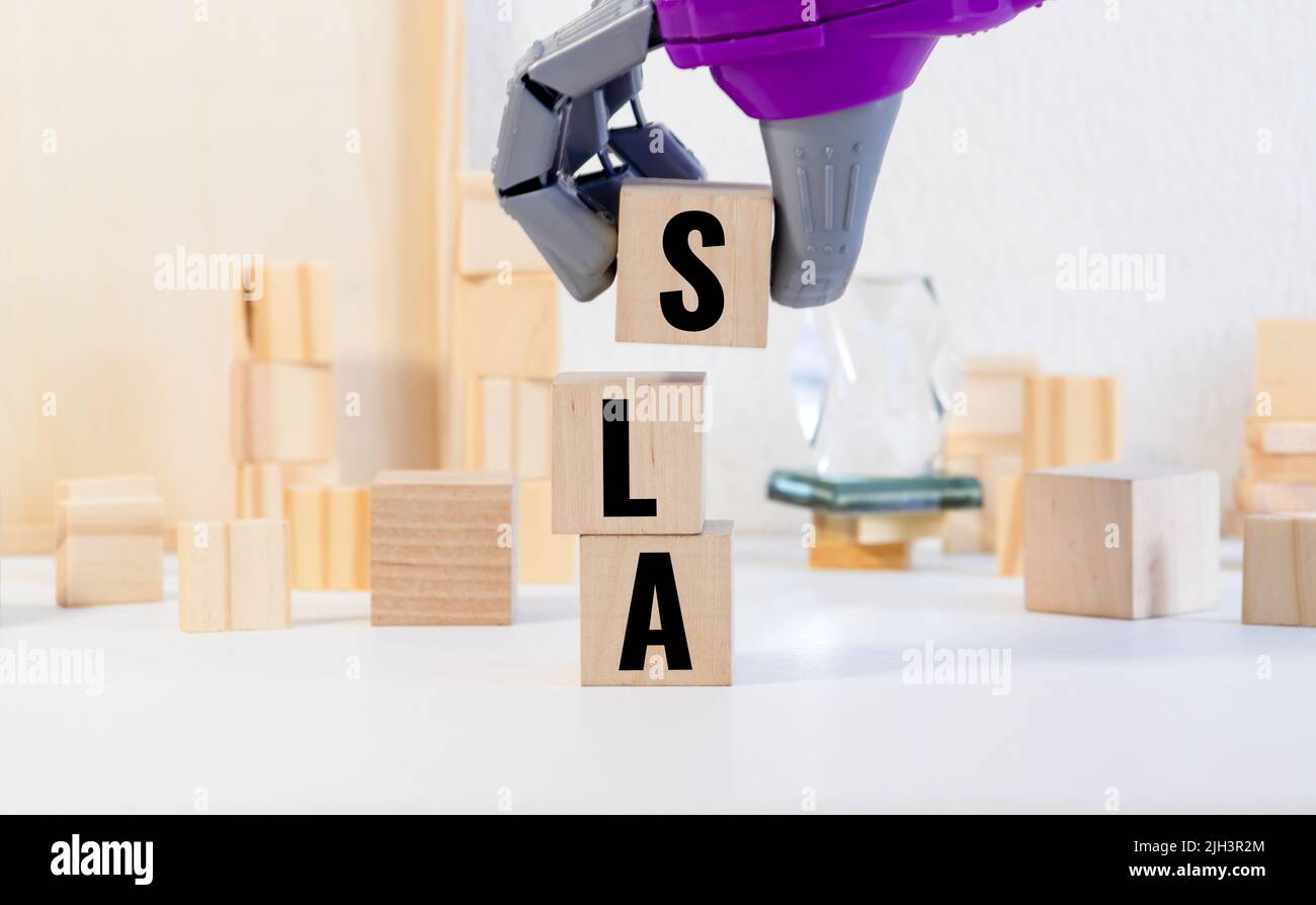Three wooden cubes with letters SLA - means Service Level Agreement ...