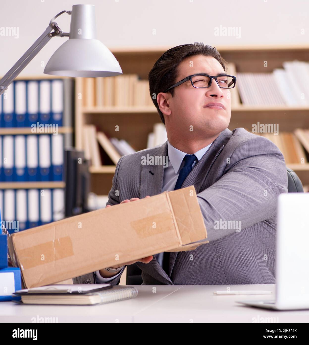 Businessman opening package in office hi-res stock photography and ...
