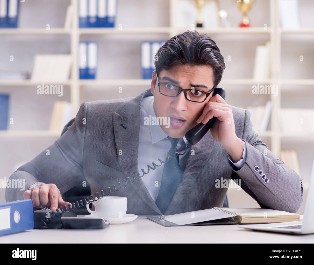 The businessman during fire alarm in office Stock Photo - Alamy