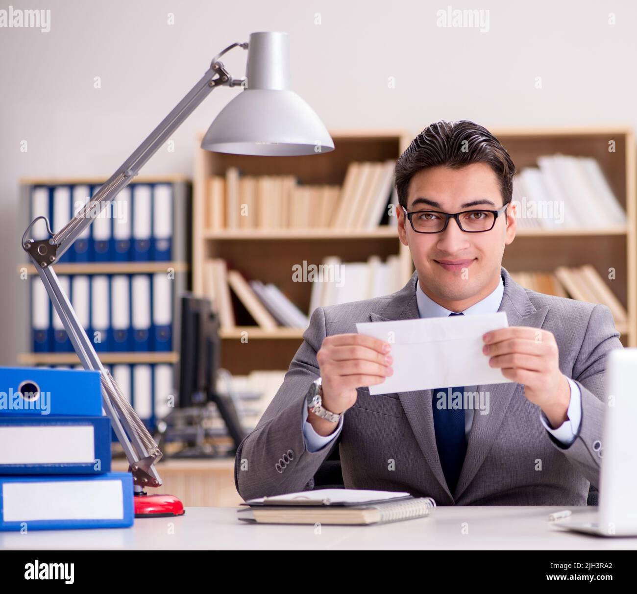 The businessman receiving letter in the office Stock Photo - Alamy