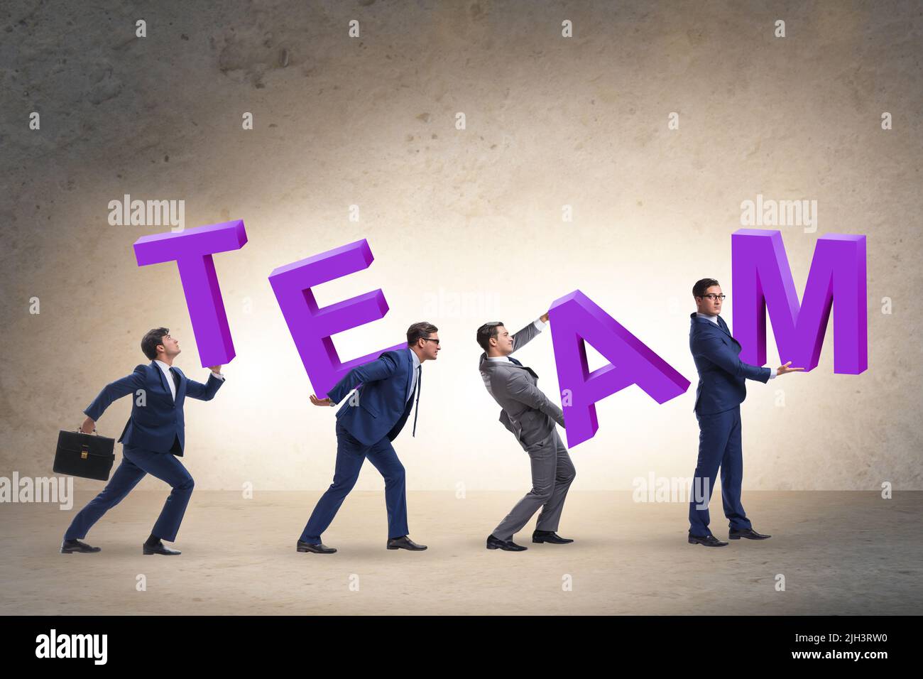 Teamwork concept with the people carrying team letters Stock Photo - Alamy
