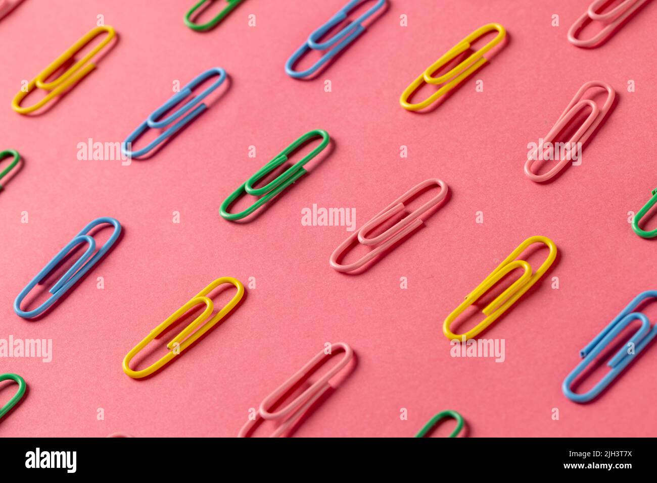 Composition of colorful clips on pin surface Stock Photo - Alamy