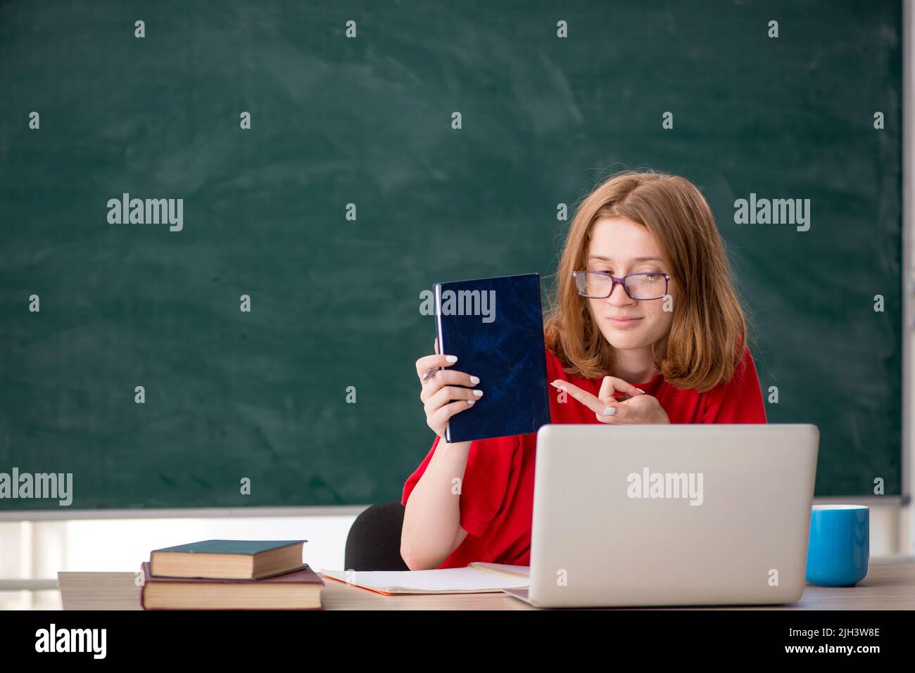 Female student preparing for exams in the classroom Stock Photo - Alamy