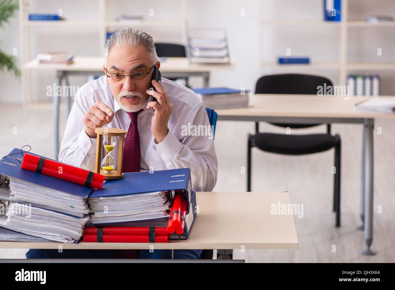 Old busynessman employee with dynamite in the office Stock Photo - Alamy