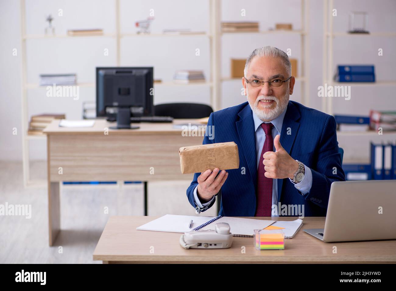 Old businessman employee ordering box via Internet Stock Photo - Alamy