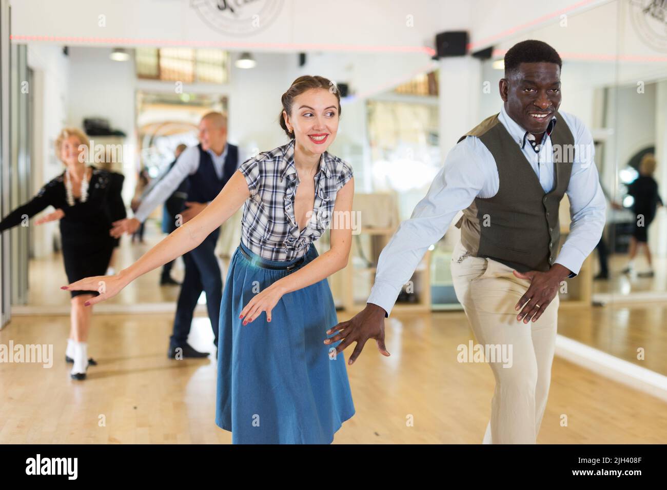 Woman with african man practising charleston dancing Stock Photo - Alamy