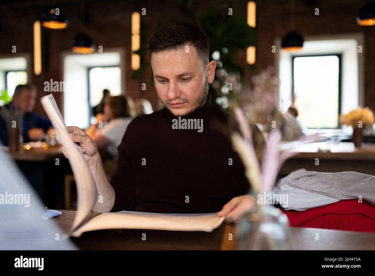 Bearded man seated table hi-res stock photography and images - Alamy