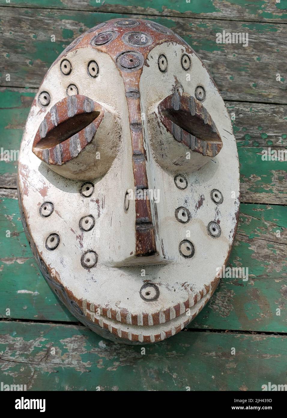 Carved african mask with decorations and symbols Stock Photo - Alamy