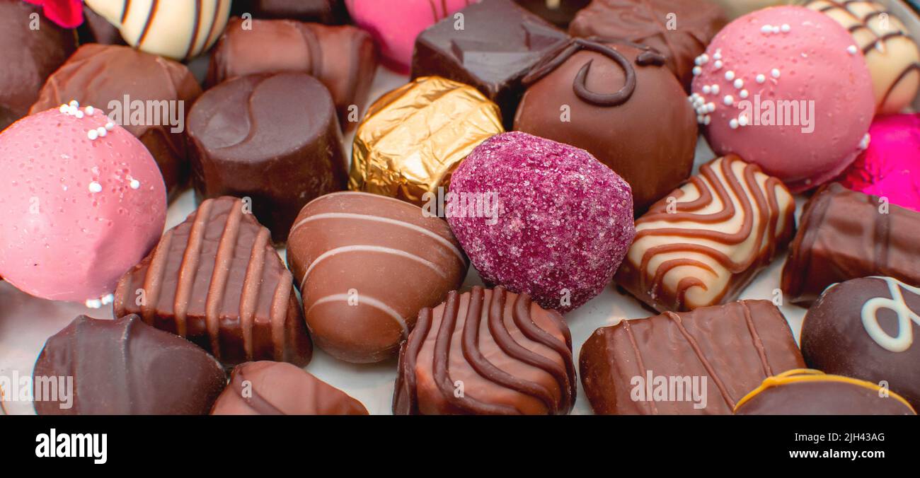 close up assortment of yummy chocolates in milk, dark and flavored ...