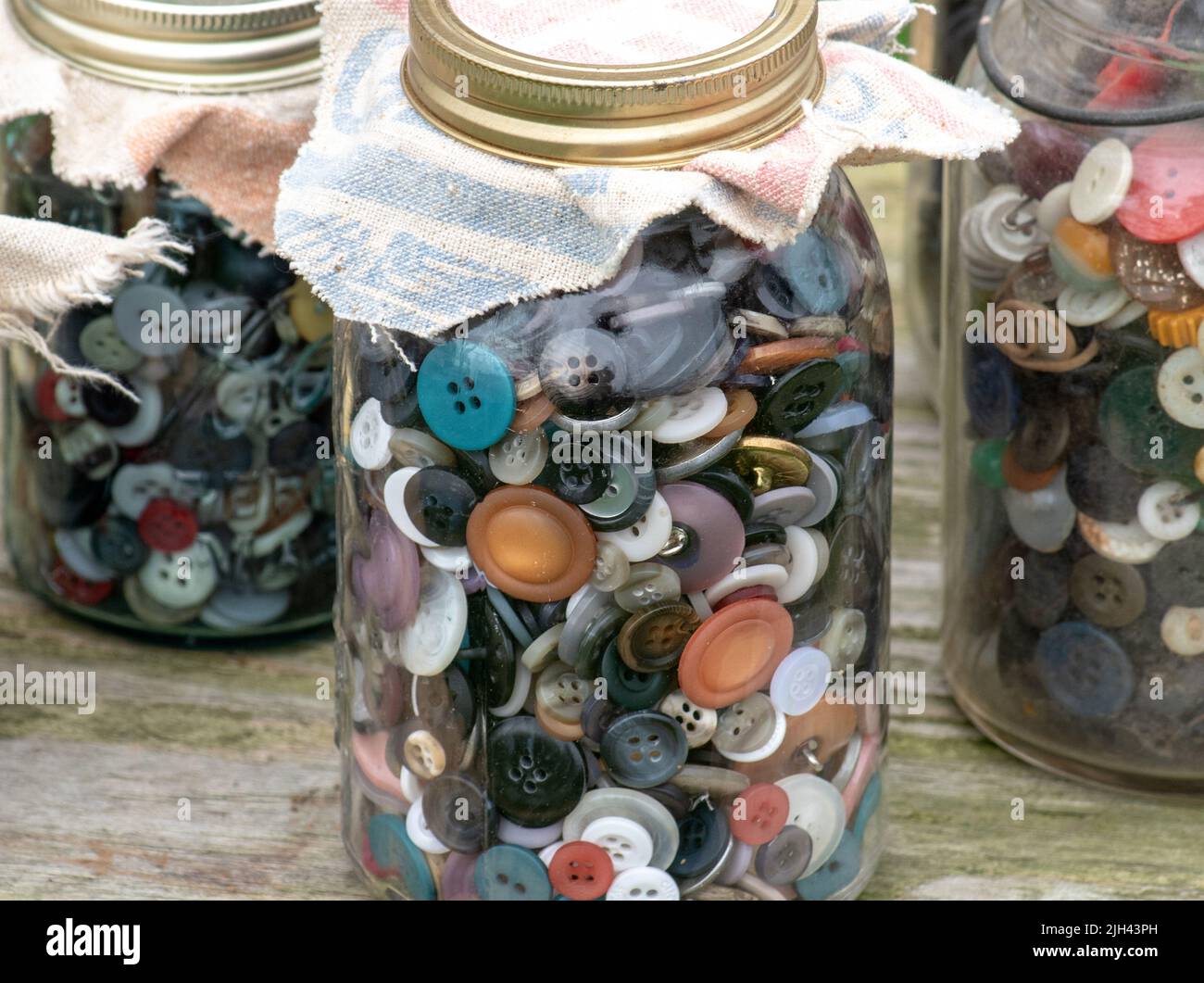 glass jars hold hundreds of buttons in all shapes, colors, and sizes ...