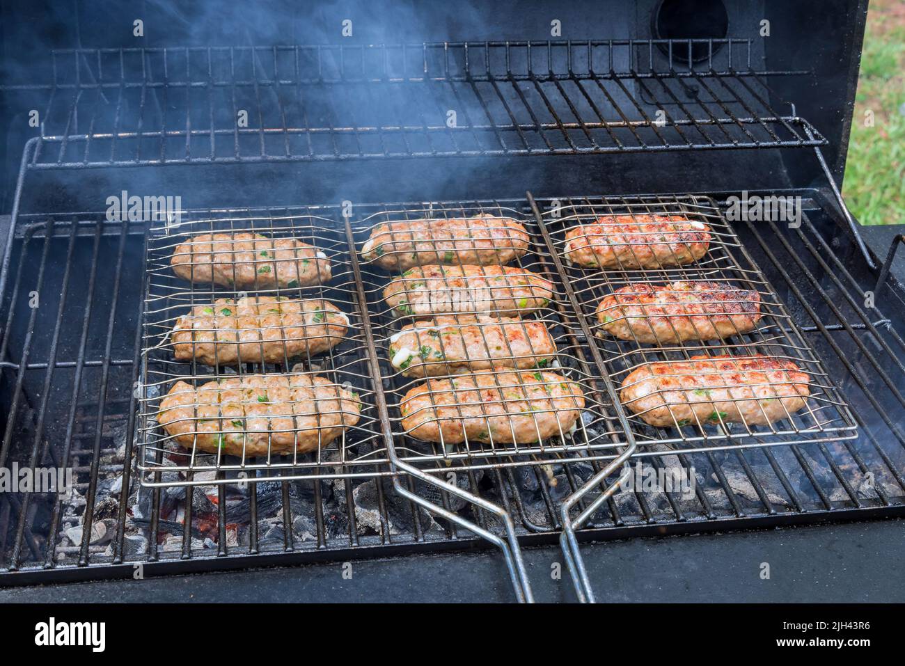 On the hot grill, mixed American barbecue food is grilled on burgers ...