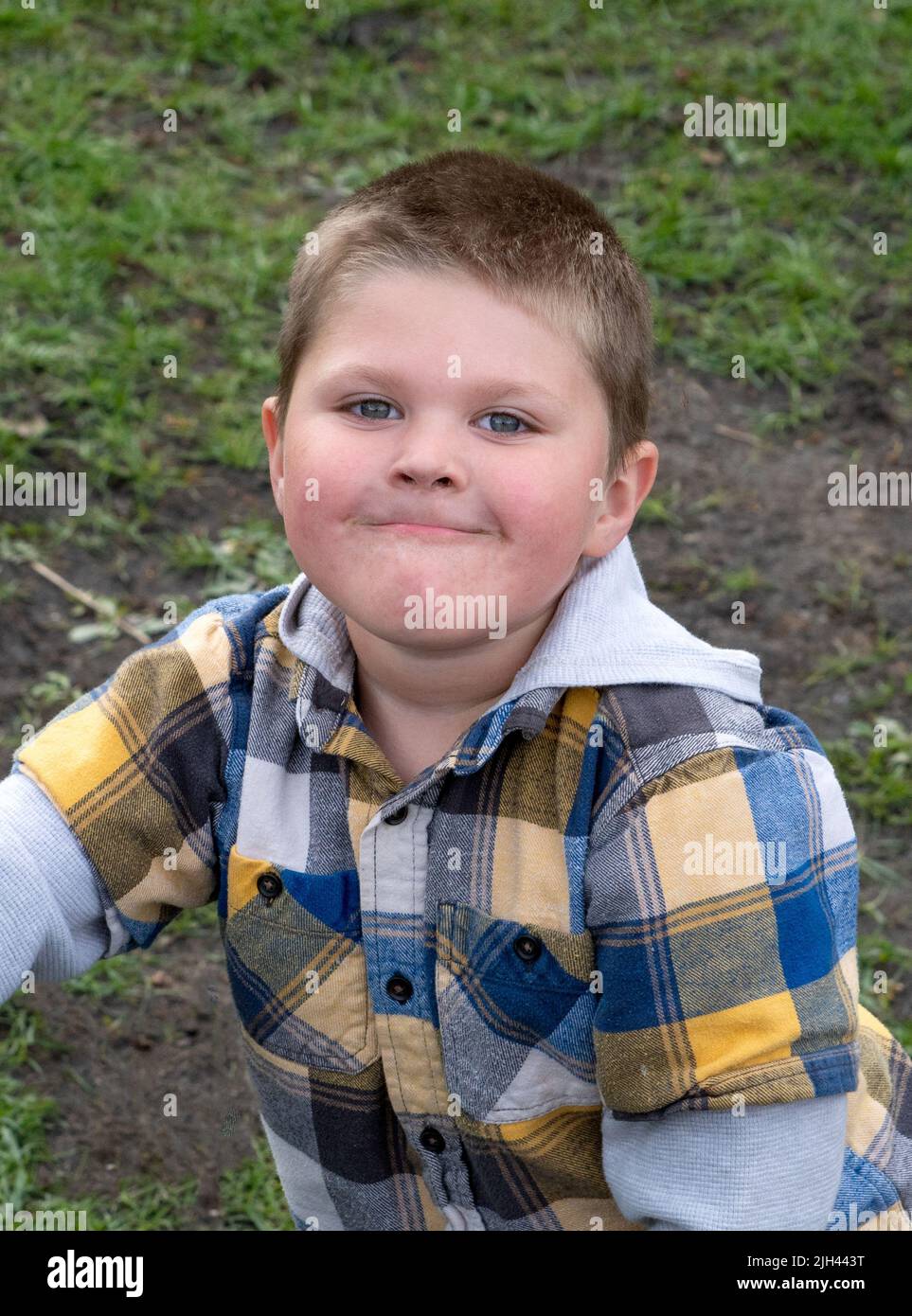 portrait of a cute boy outside with a smug grin Stock Photo - Alamy