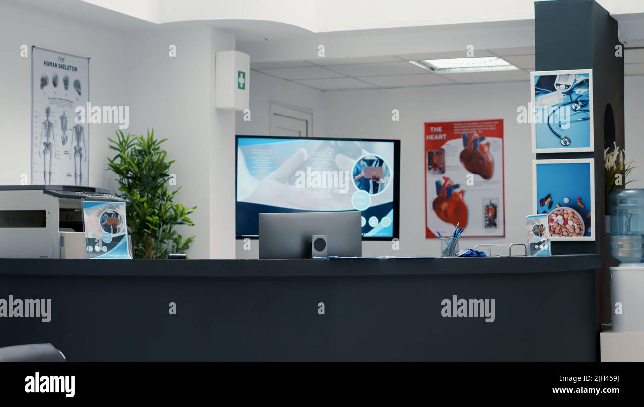 Nobody at empty hospital reception counter on facility floor to help ...