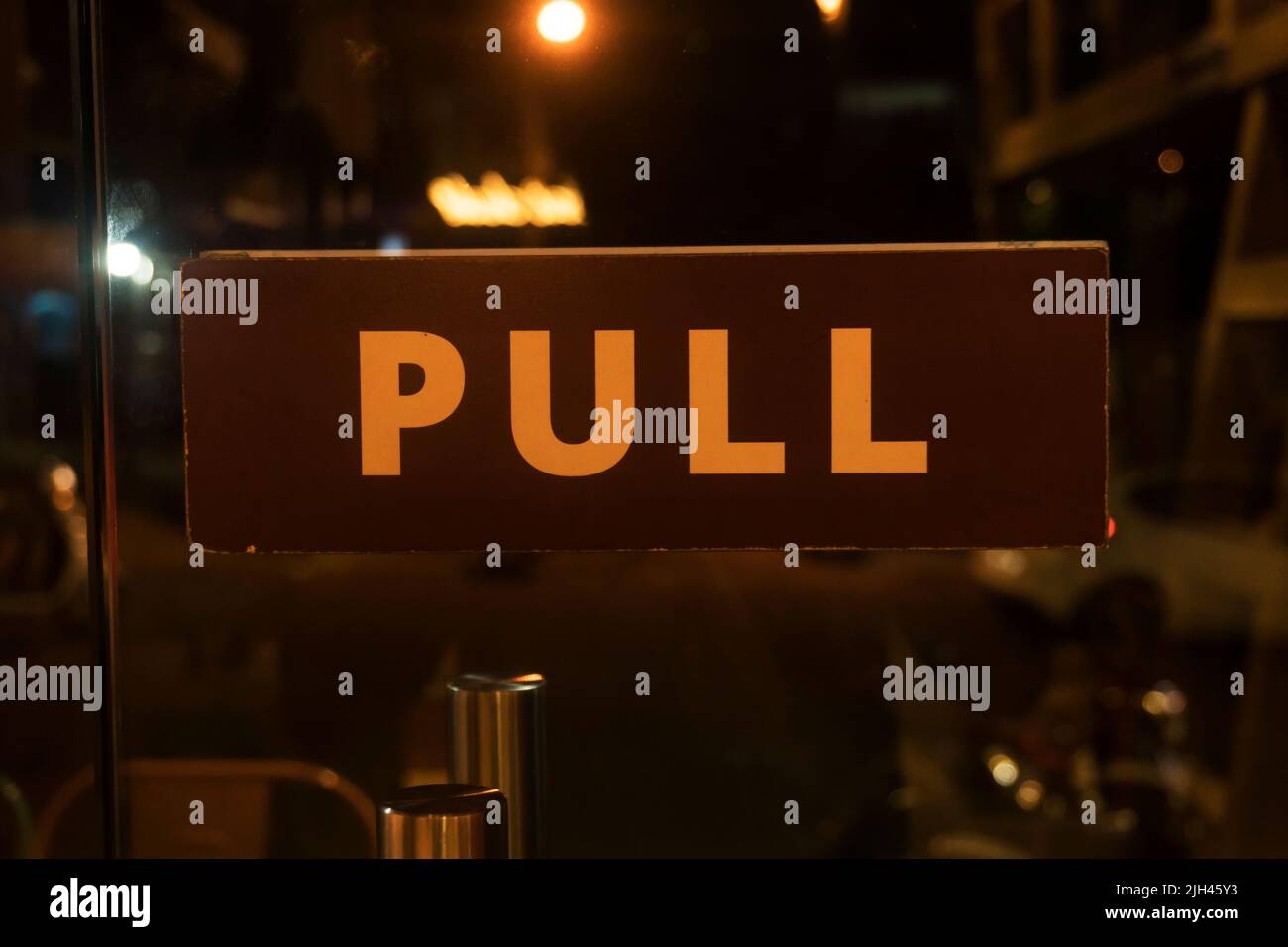 Pull sign board on a glass door Stock Photo - Alamy