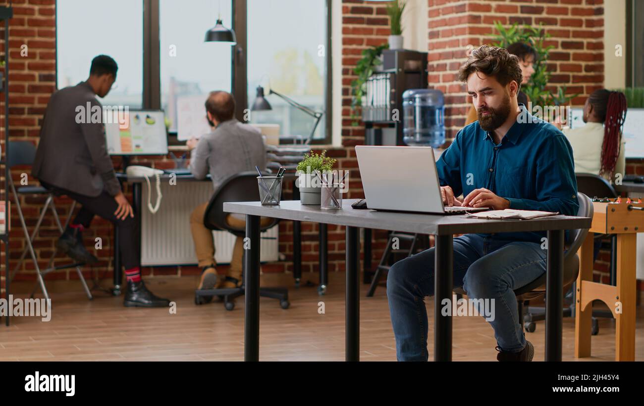Project manager using laptop to work on business report, creating ...