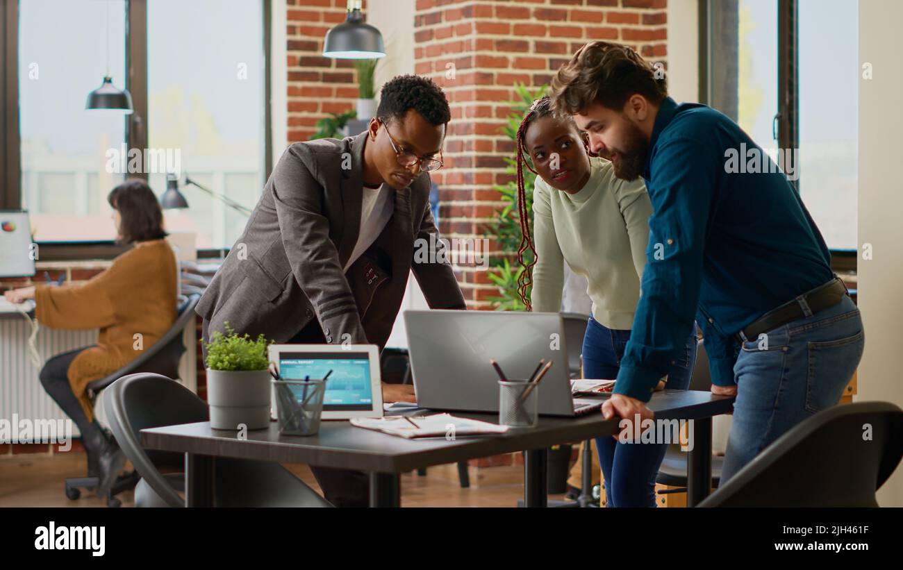 Multiethnic group of people planning business project with charts and ...