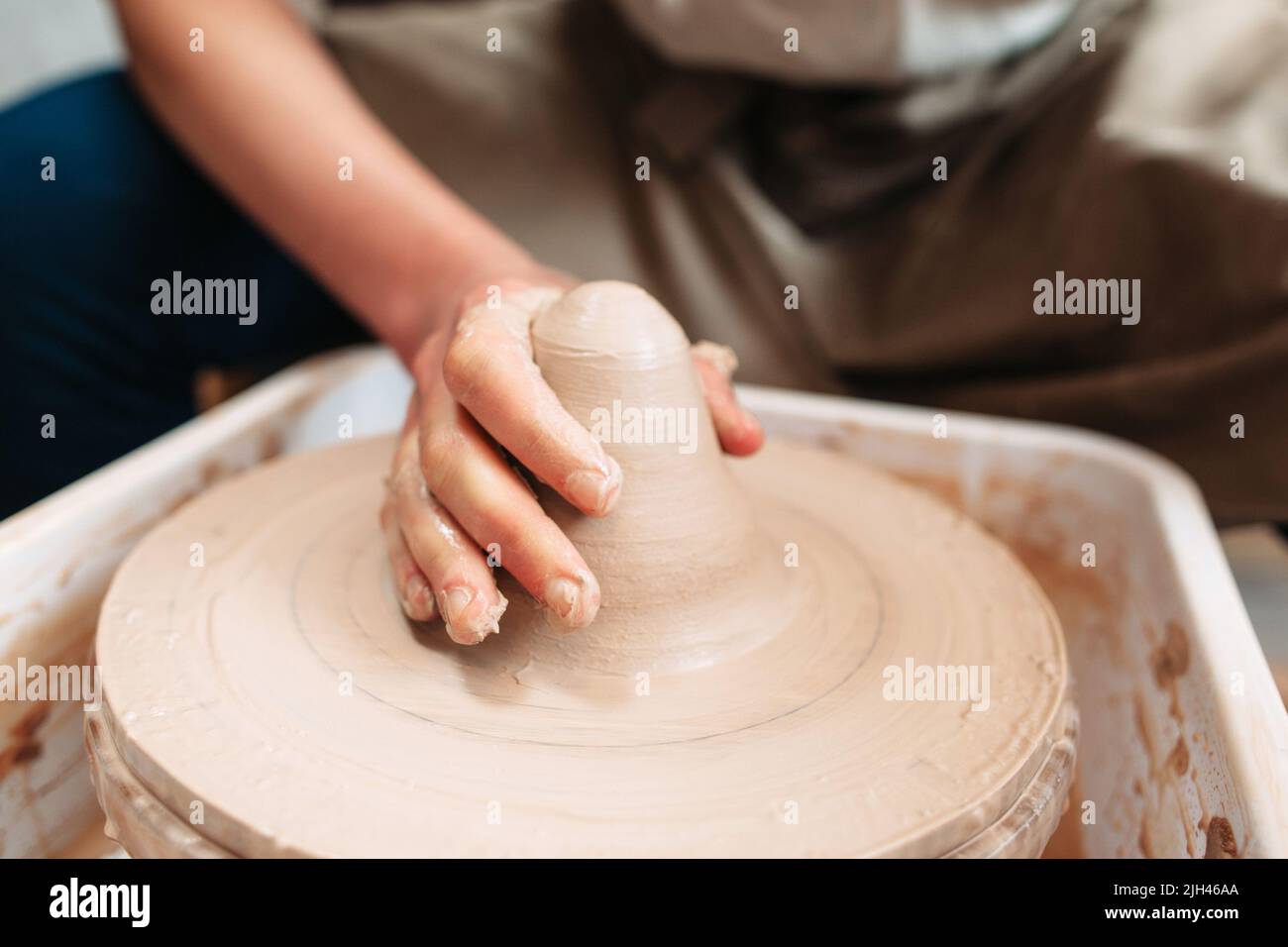 Hand of potter on clay at workplace Stock Photo - Alamy