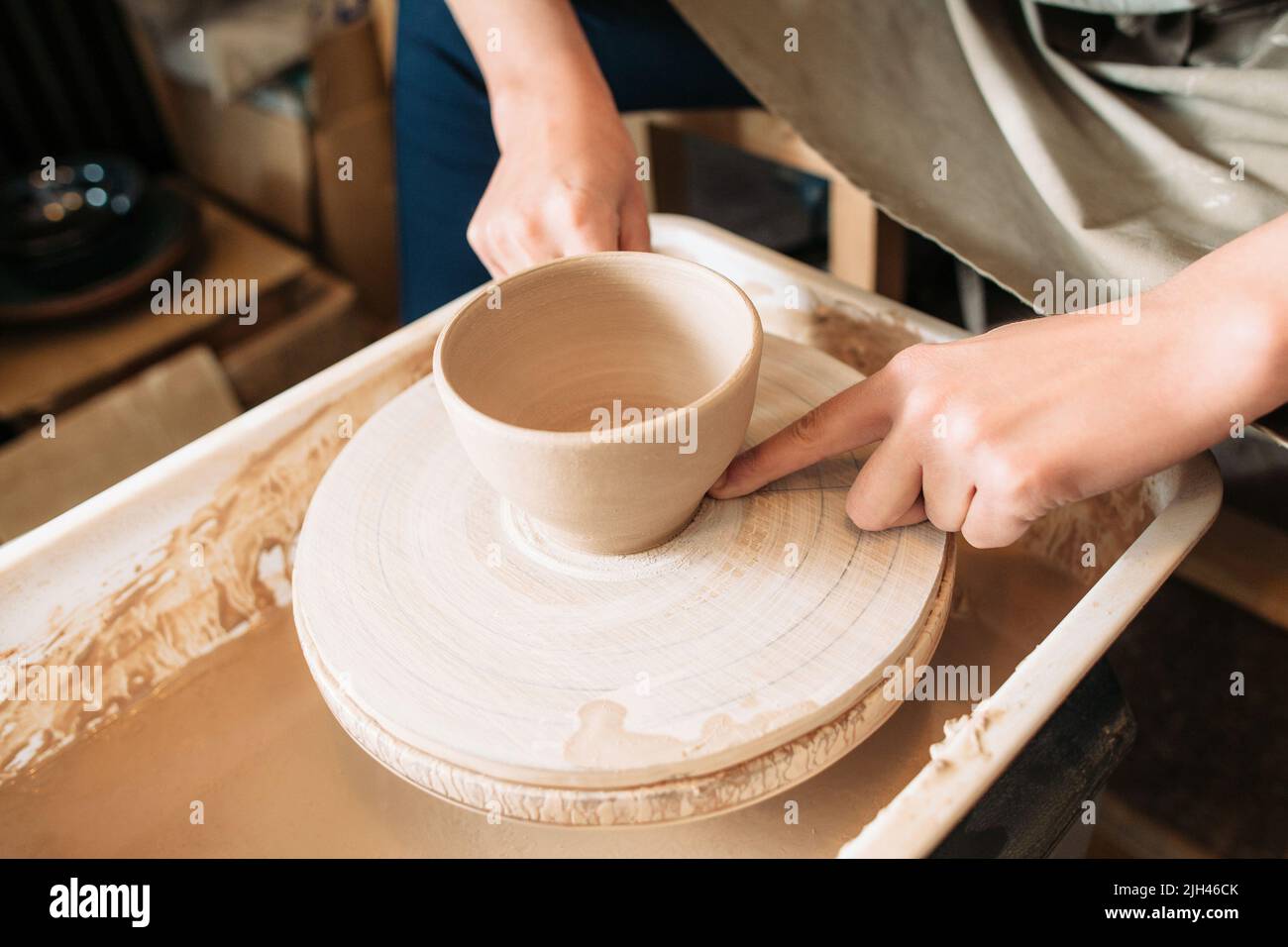 Potter working on pottery wheel in studio Stock Photo - Alamy