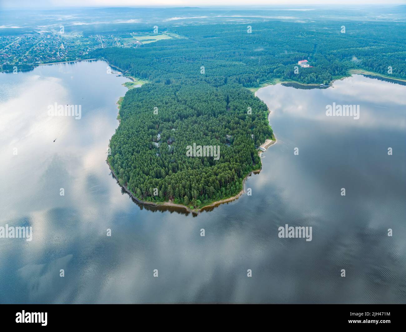 Big lake with green shores in bright sun light, aerial landscape ...
