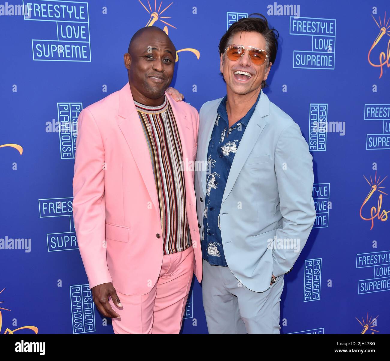 Wayne Brady and John Stamos walking on the red carpet at the opening ...