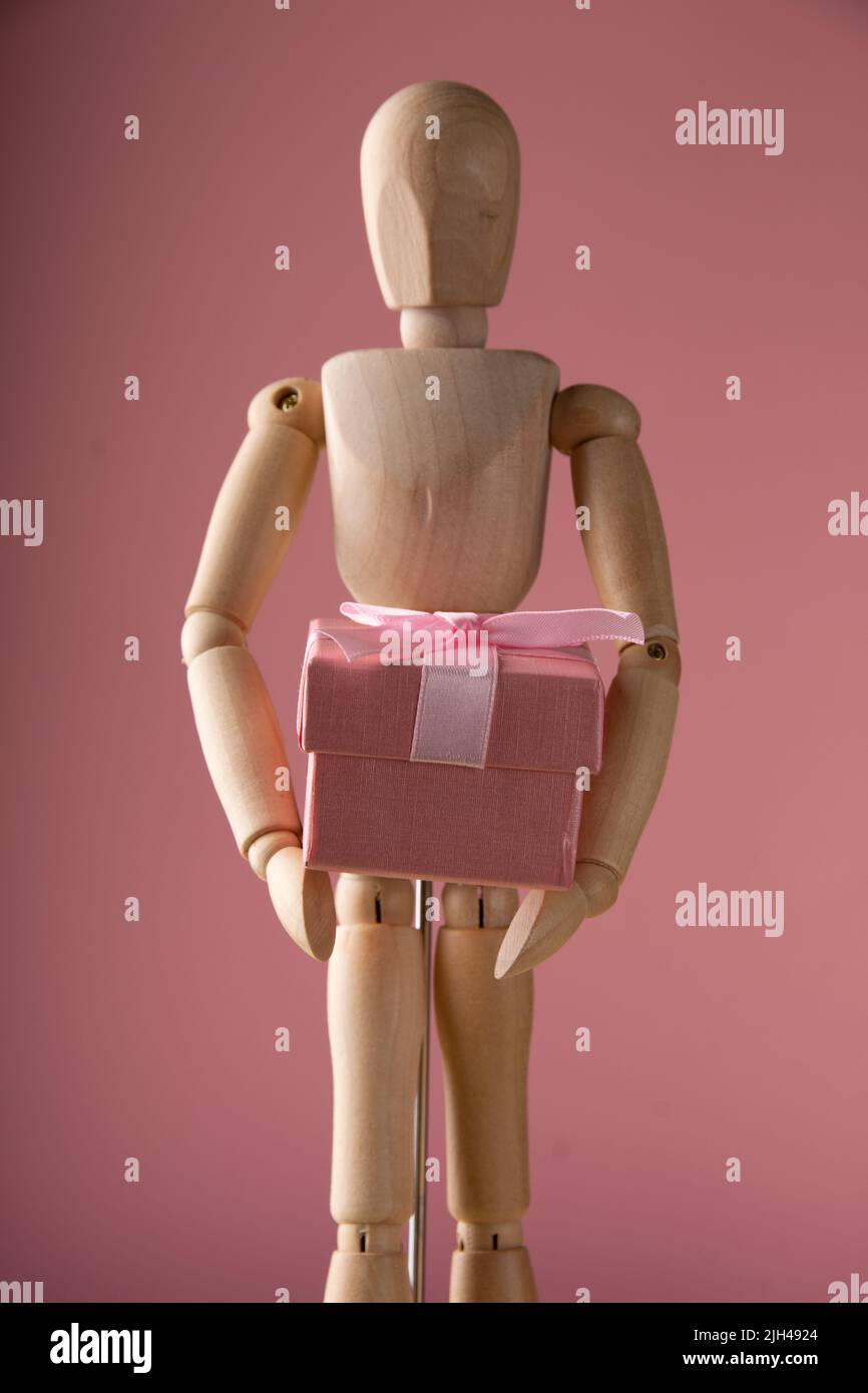 Hand holds wooden figurine hi-res stock photography and images - Alamy