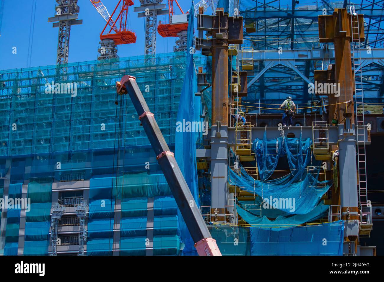 Crane at the under construction in Tokyo long shot Stock Photo - Alamy