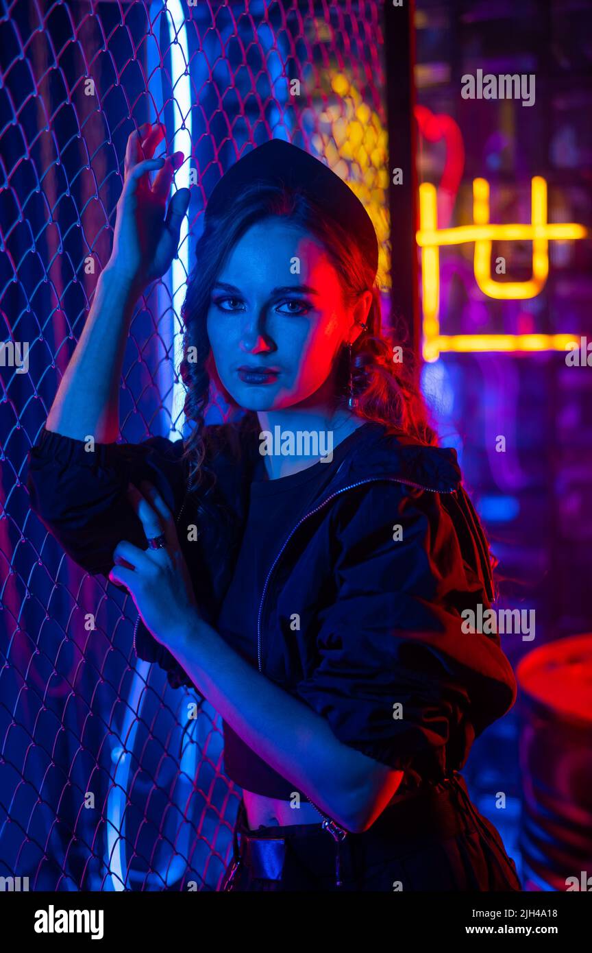 Caucasian woman posing in neon studio Stock Photo - Alamy