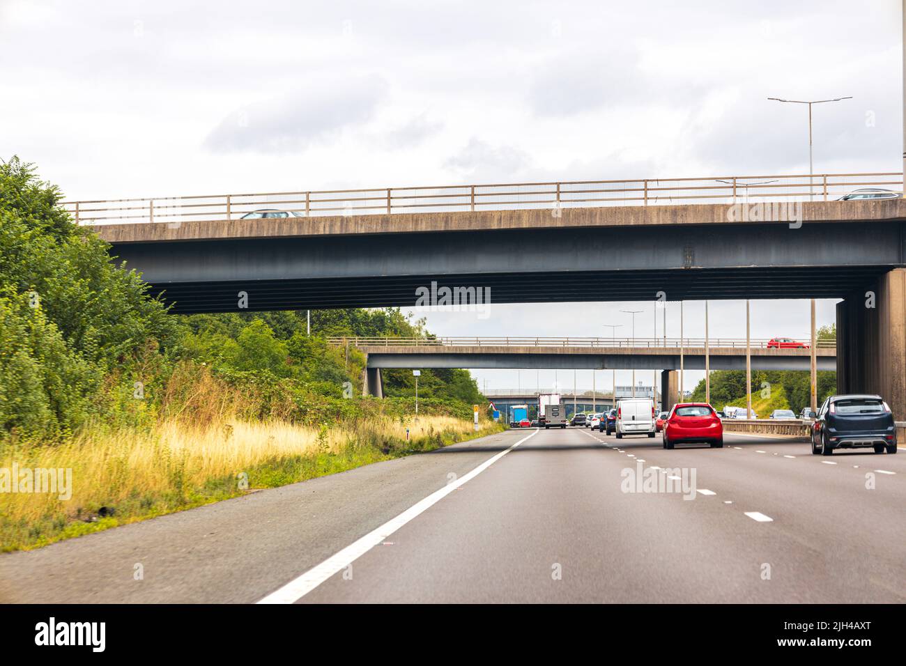 A motorway view of an upcoming bridge overhead, in the United Kingdom ...