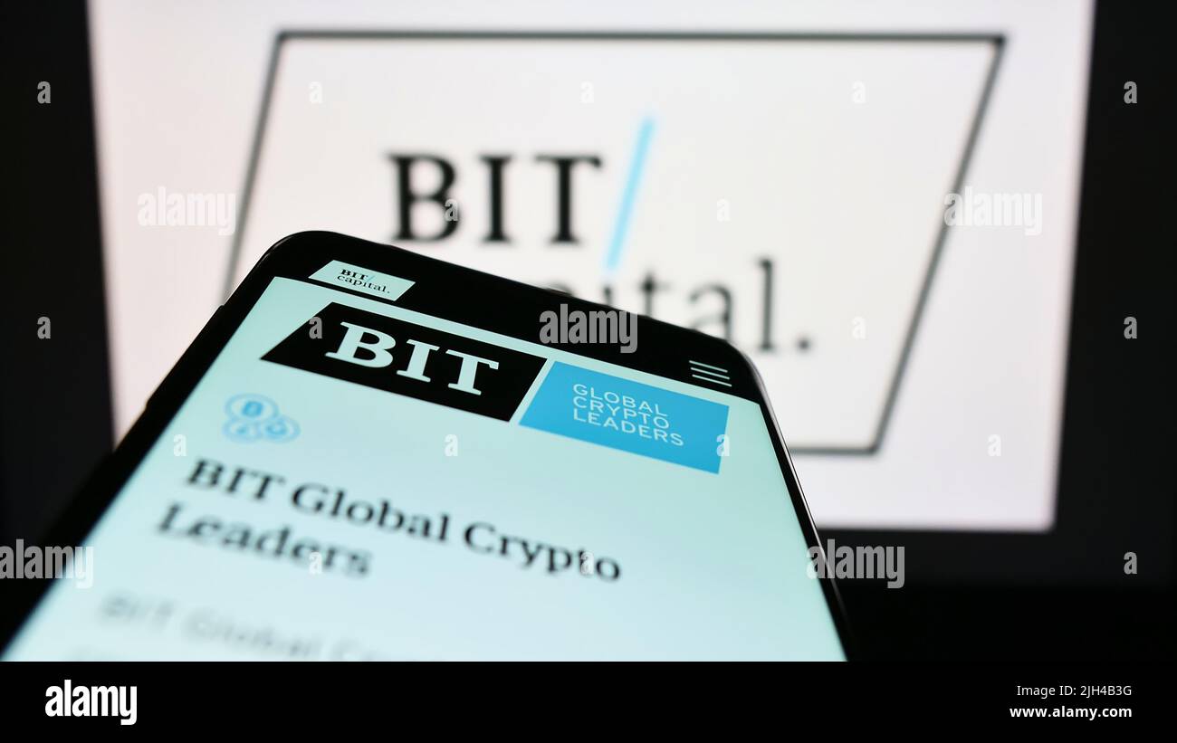 Smartphone with webpage of German financial company BIT Capital GmbH on screen in front of ...