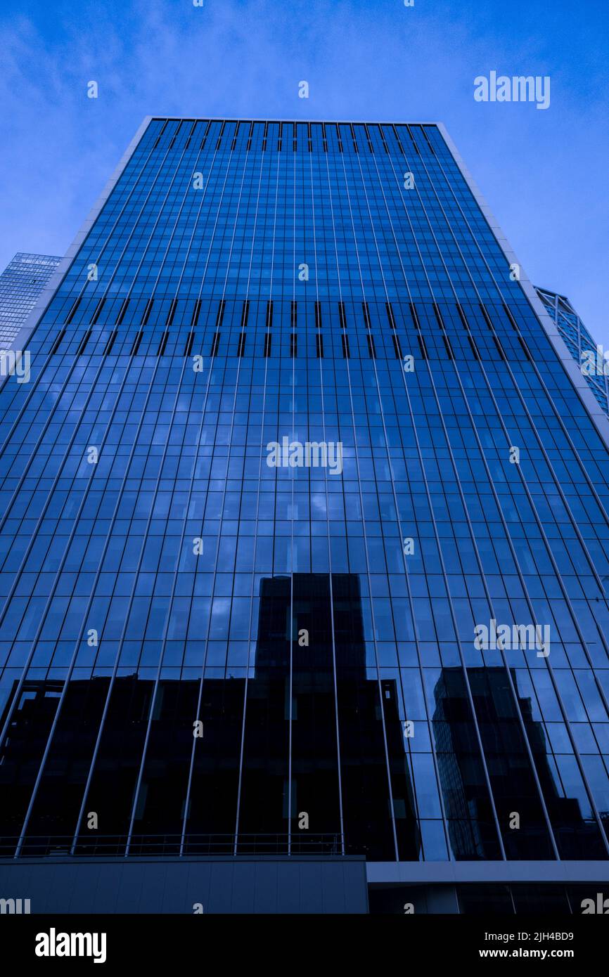 A ground perspective of some high rise buildings in the middle of a ...