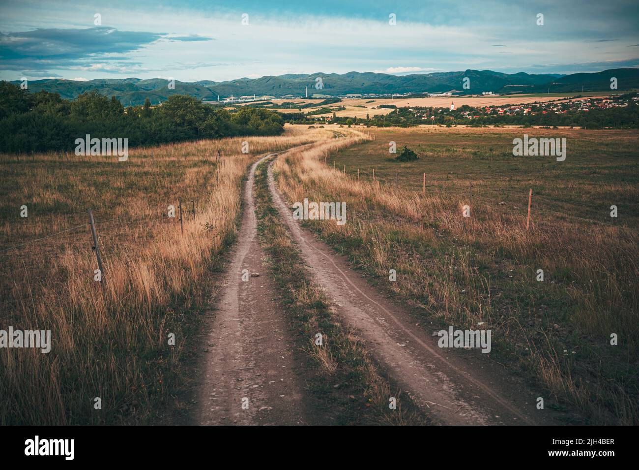 Footpath in the field behind the village. Peaceful summer scene in ...