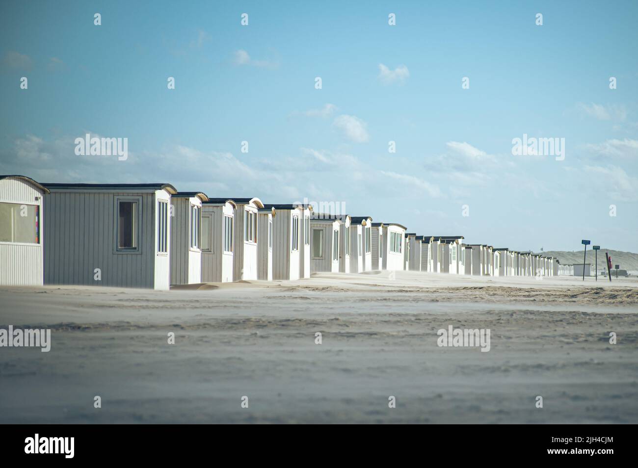 A lot of tiny white beach huts at Lokken in Denmark. High quality photo ...