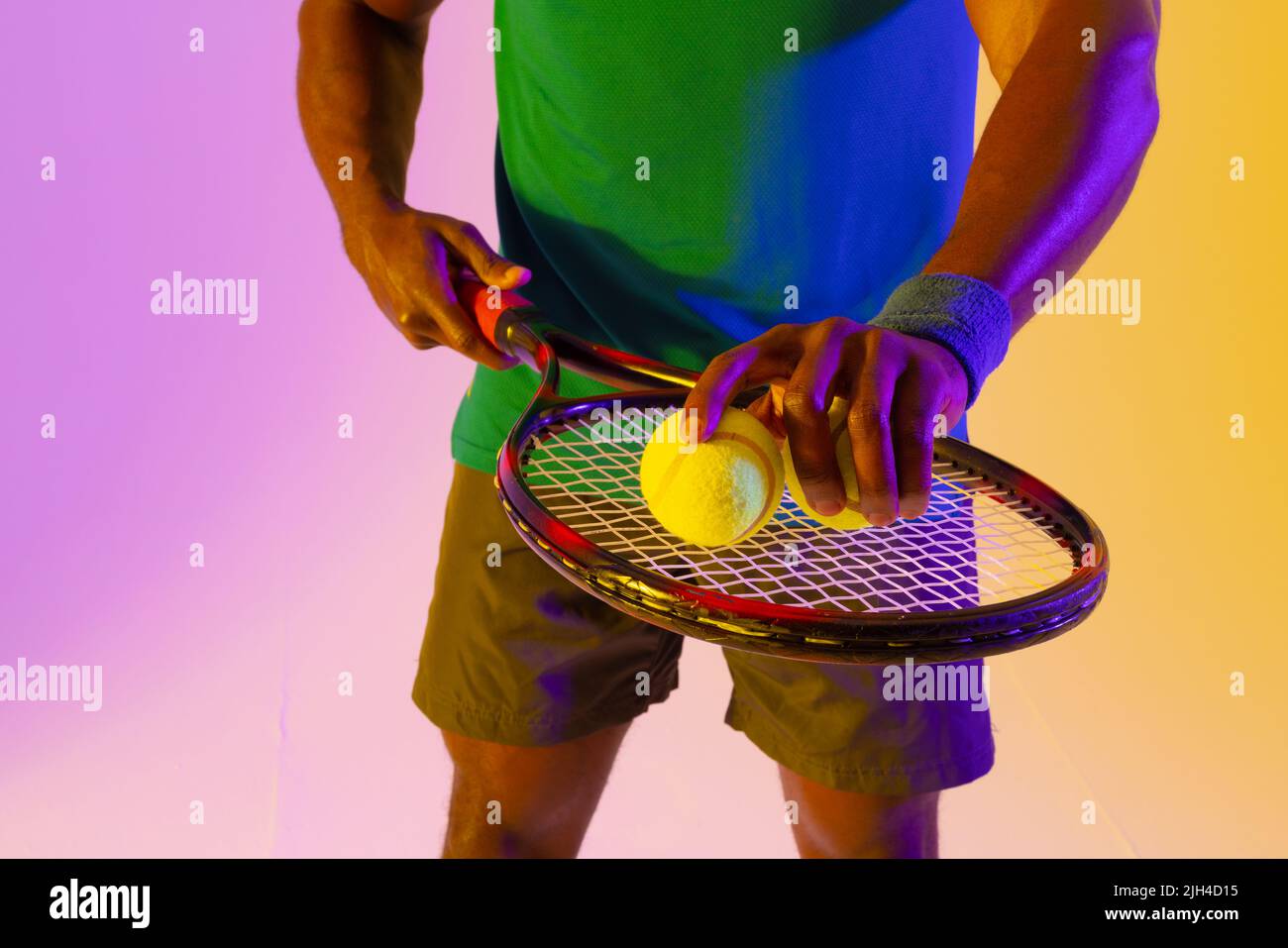 Image of midsection of african american male tennis player in violet ...