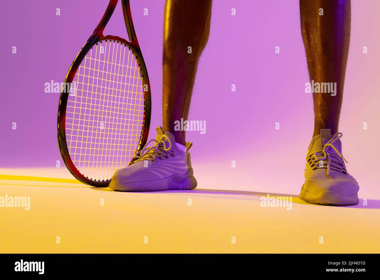 Image of legs of african american male tennis player in violet and ...