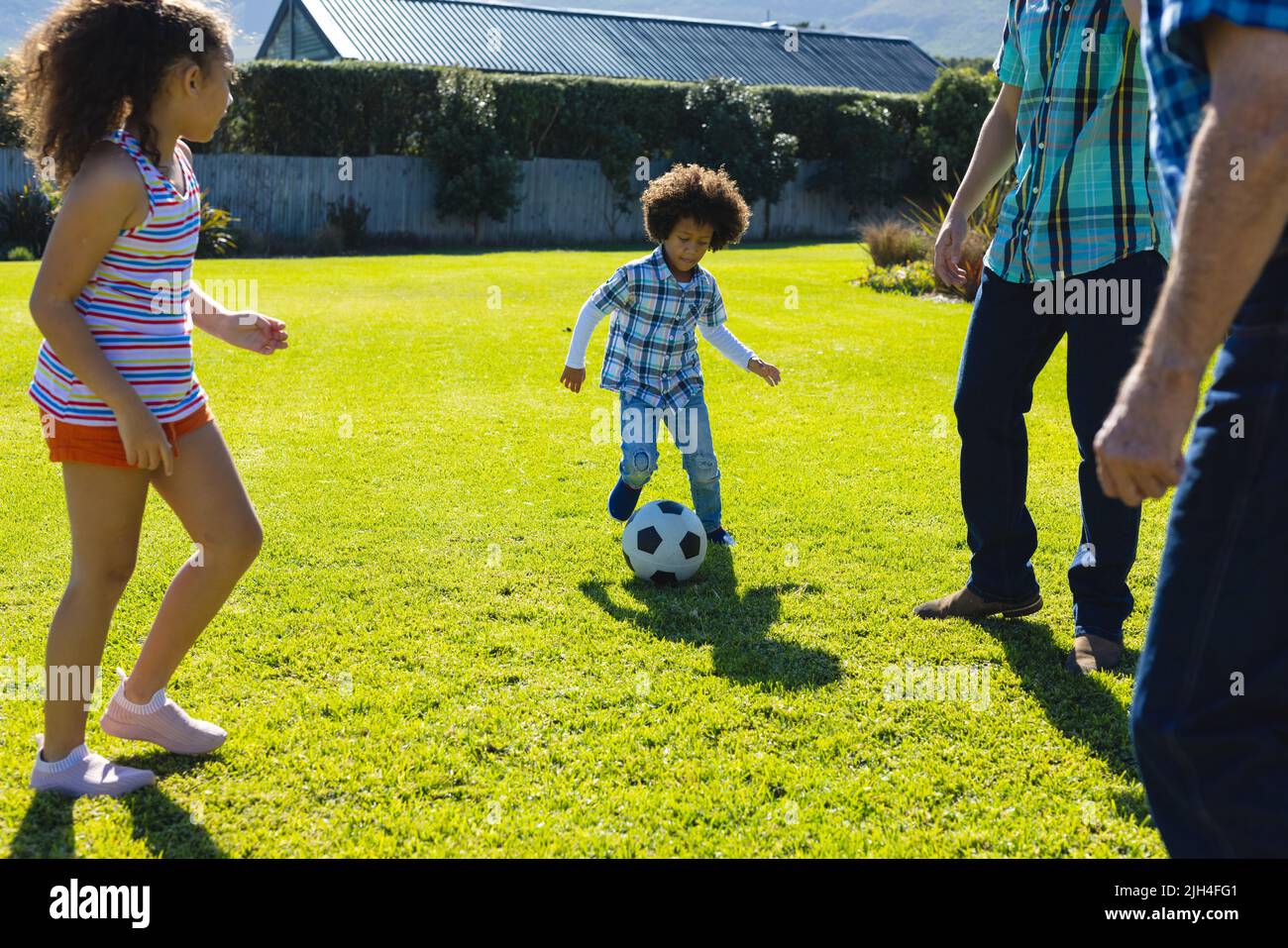 Family playing soccer on grassy hi-res stock photography and images - Alamy