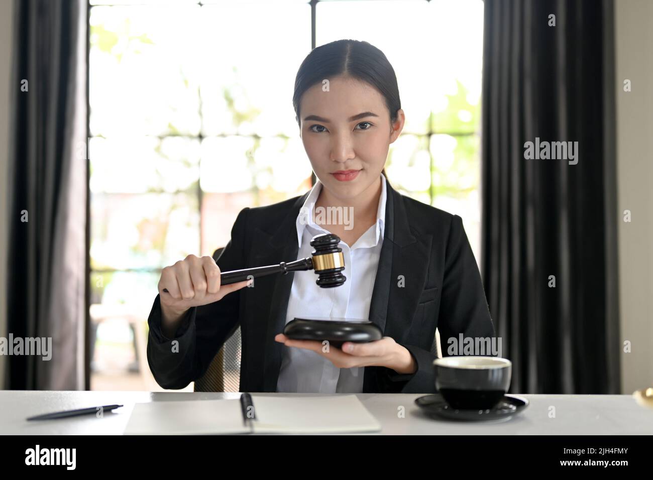 Female judge holding gavel hi-res stock photography and images - Alamy