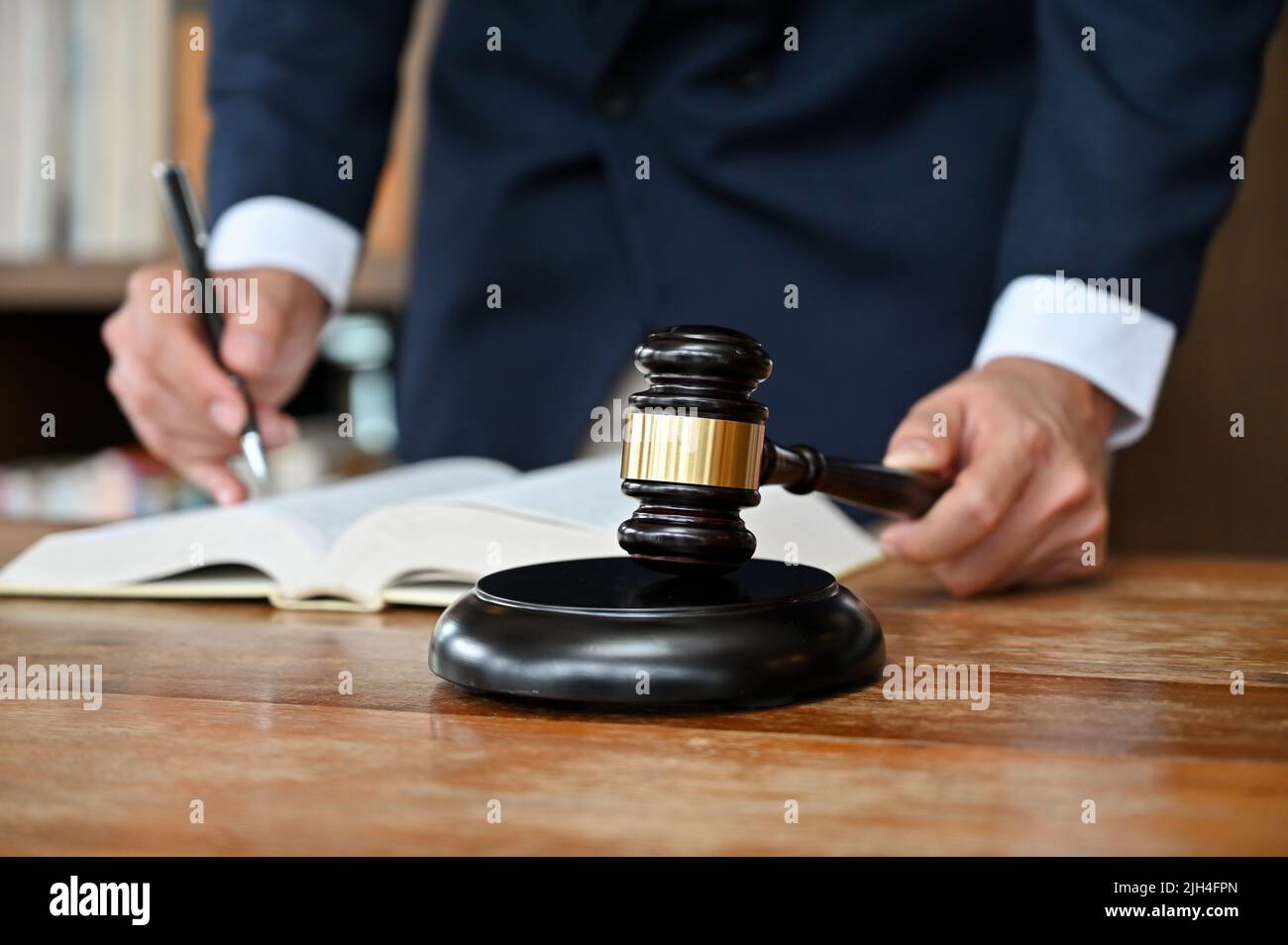 Professional and successful male lawyer in formal suit reading a law ...