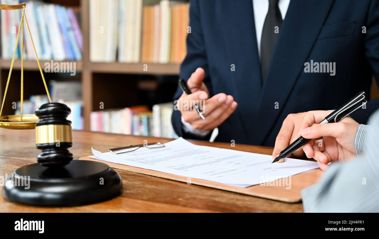 Successful and smart male lawyer giving an advice and counselling to ...