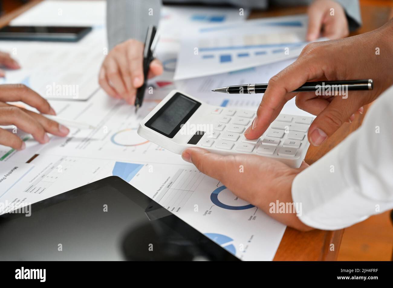 A group of business accountant working together, checking and analysing ...