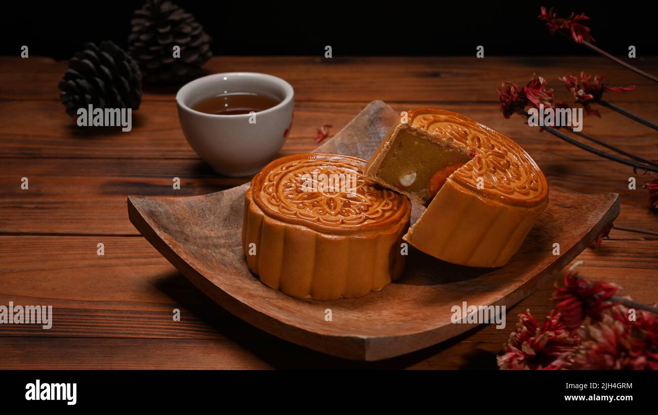 Traditional mooncakes on wooden plate, for Chinese mid Autumn festival celebration Stock Photo ...